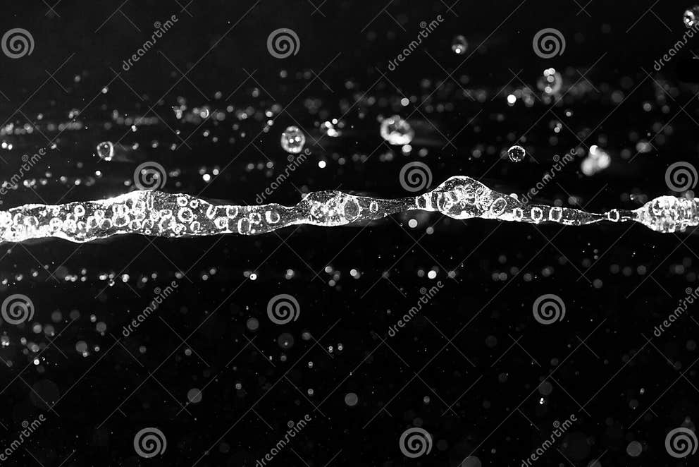 Water Jet with Spray on a Black Background Stock Image - Image of black ...