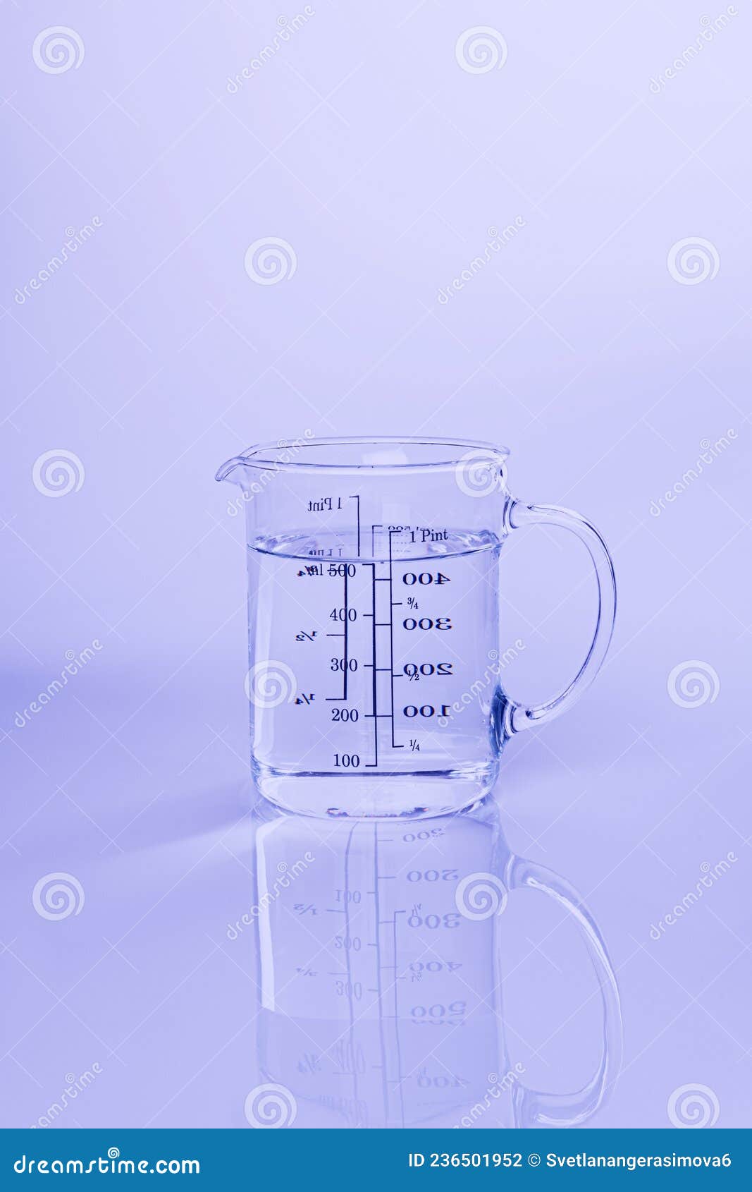 Water in a Measuring Container on a Light Blue Background Stock Photo ...