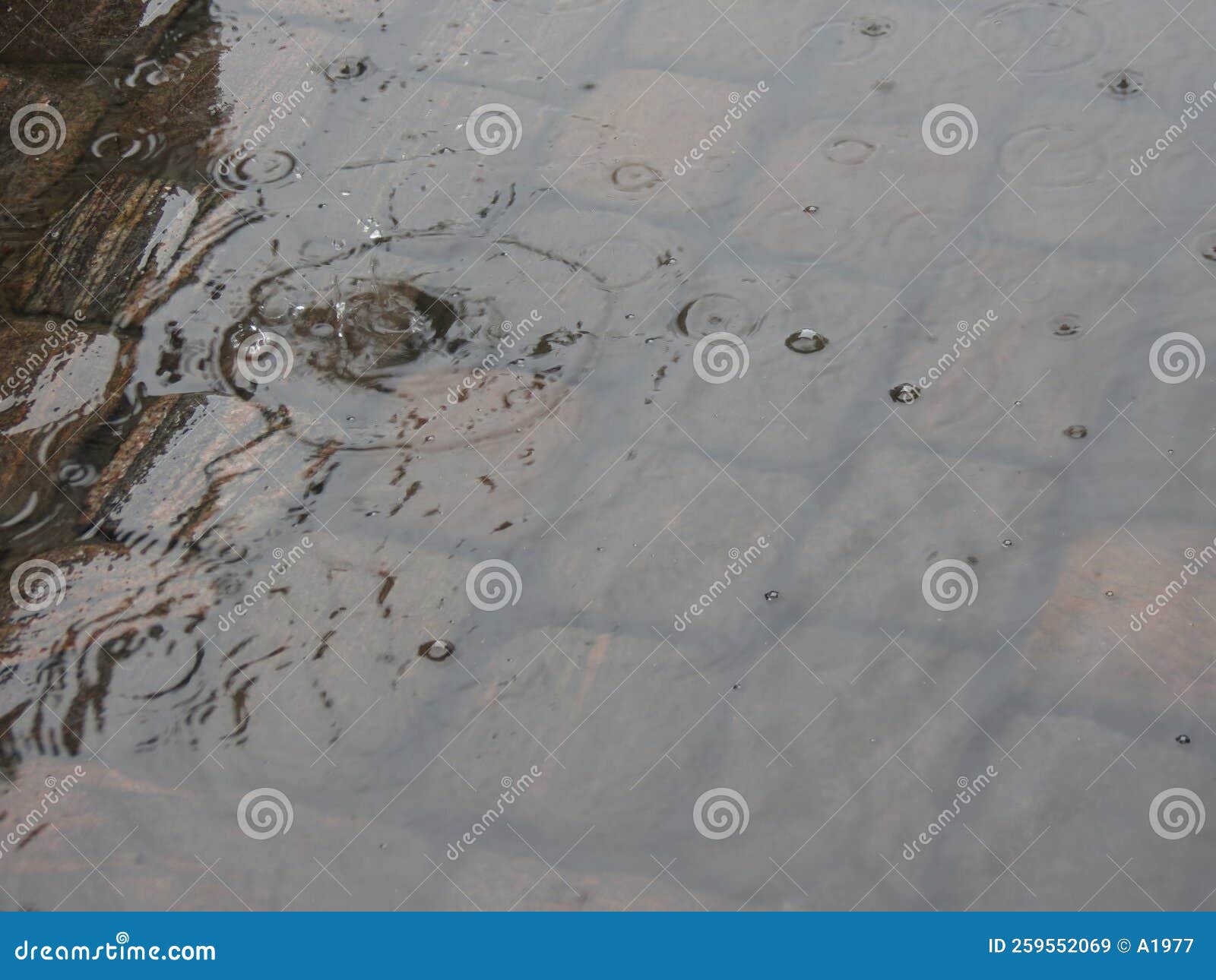 Water Over Cobblestone Pavement with Rain Falling Over Stock Image ...