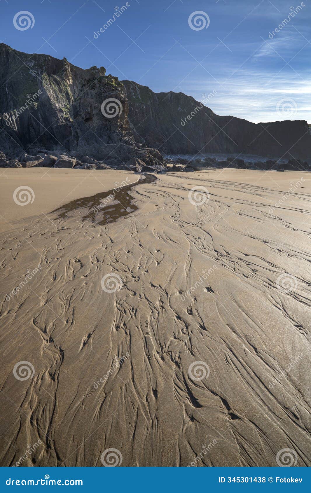 Water patterns in the sand stock photo. Image of shore - 345301438