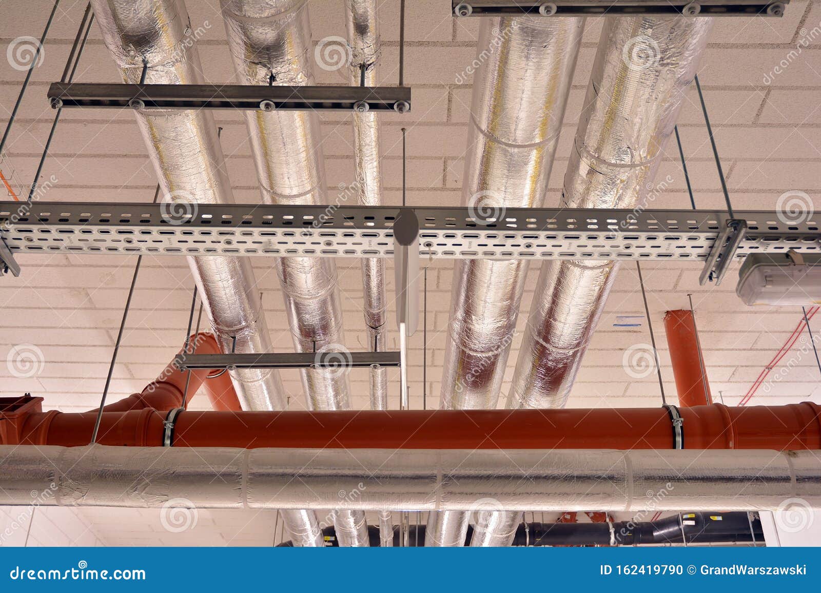 Water Pipes and Cable Trays Run Under Ceiling of a Building Stock Photo ...