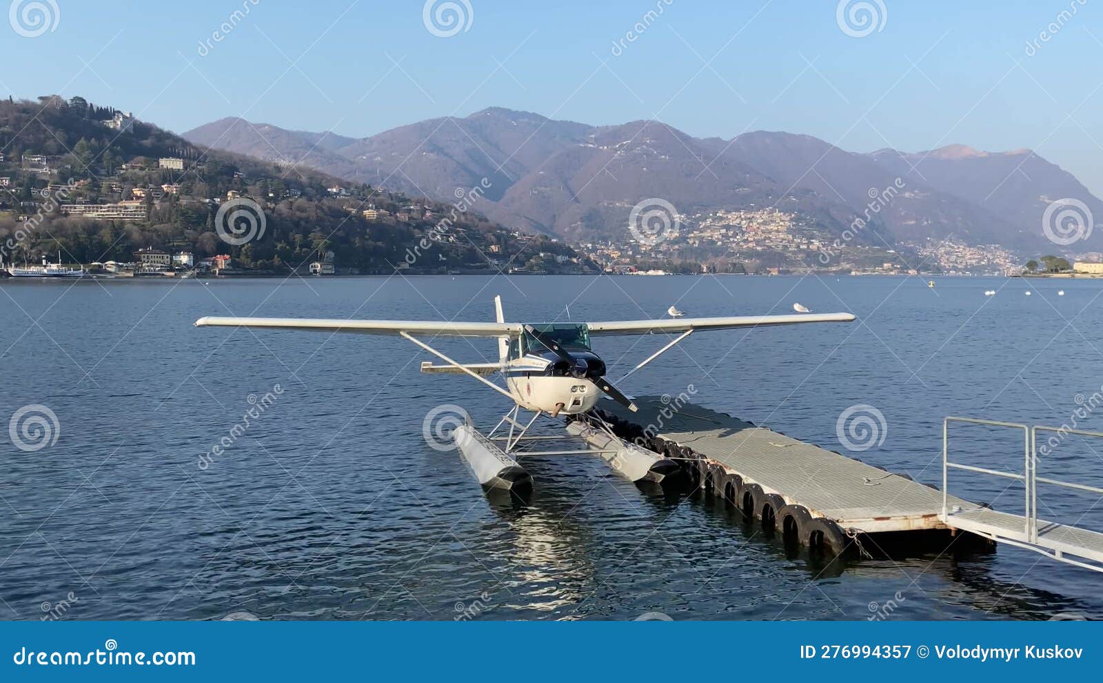 A Water Plane on a Lake, with a Beautiful Landscape of Mountains in the ...