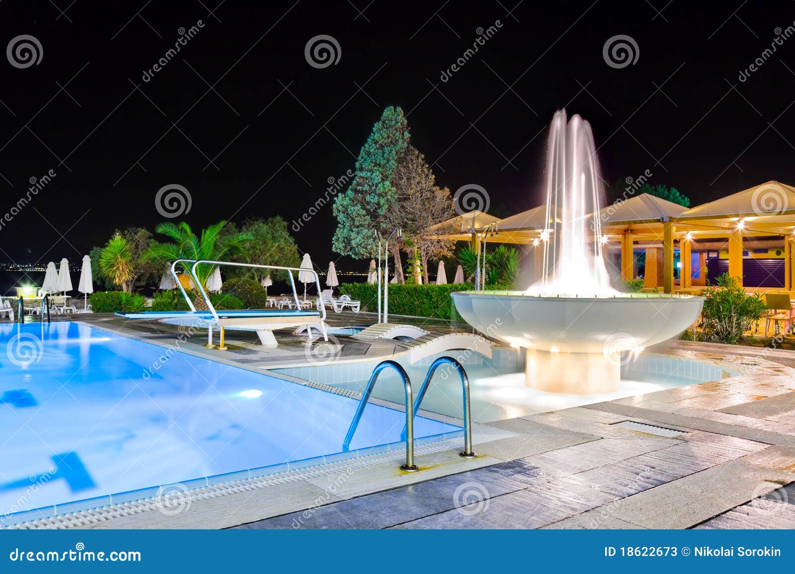 Water Pool and Fountain at Night Stock Image - Image of pool, chair ...
