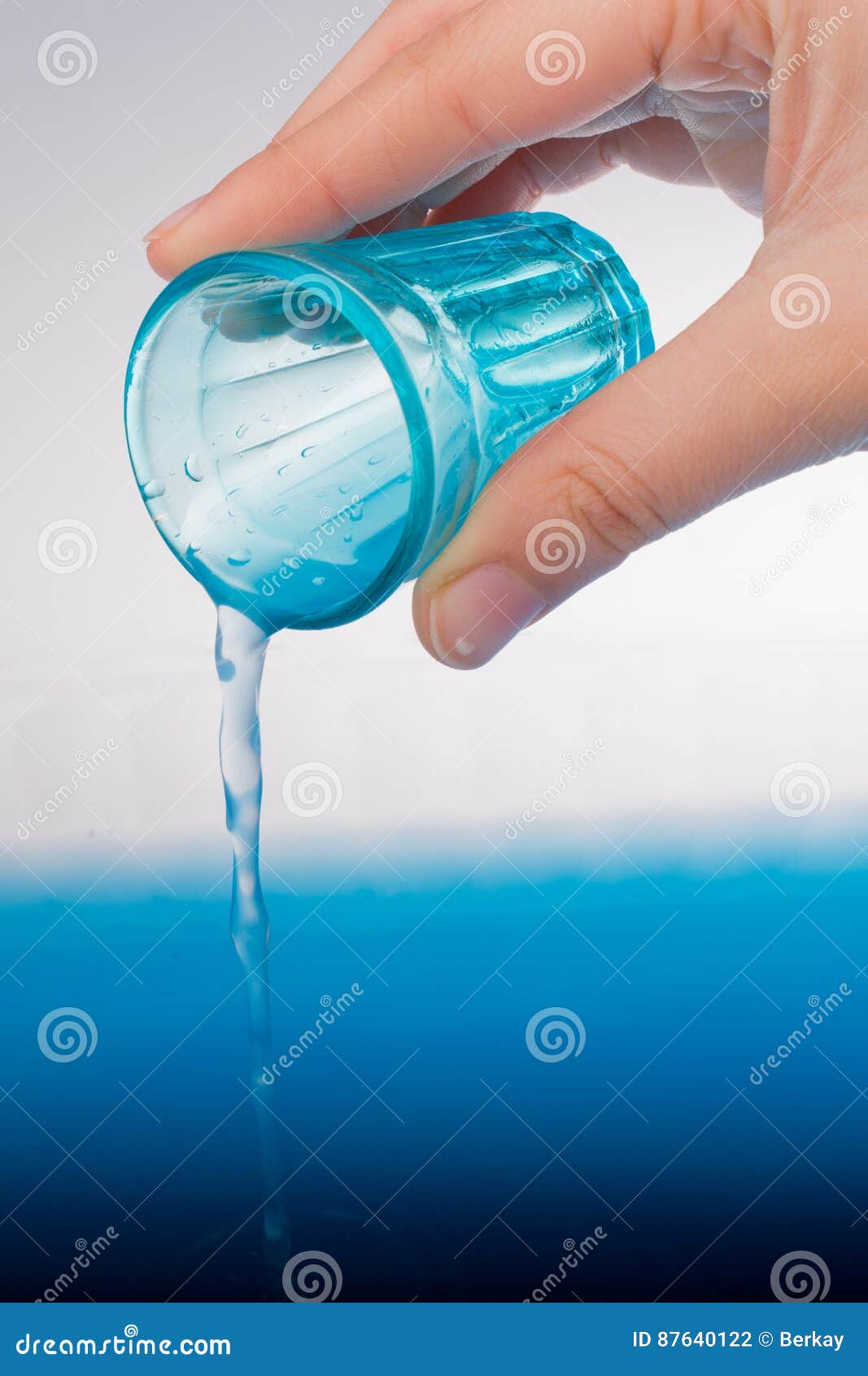 Water Pouring Down Out of Glass in Hand Stock Photo - Image of drop ...