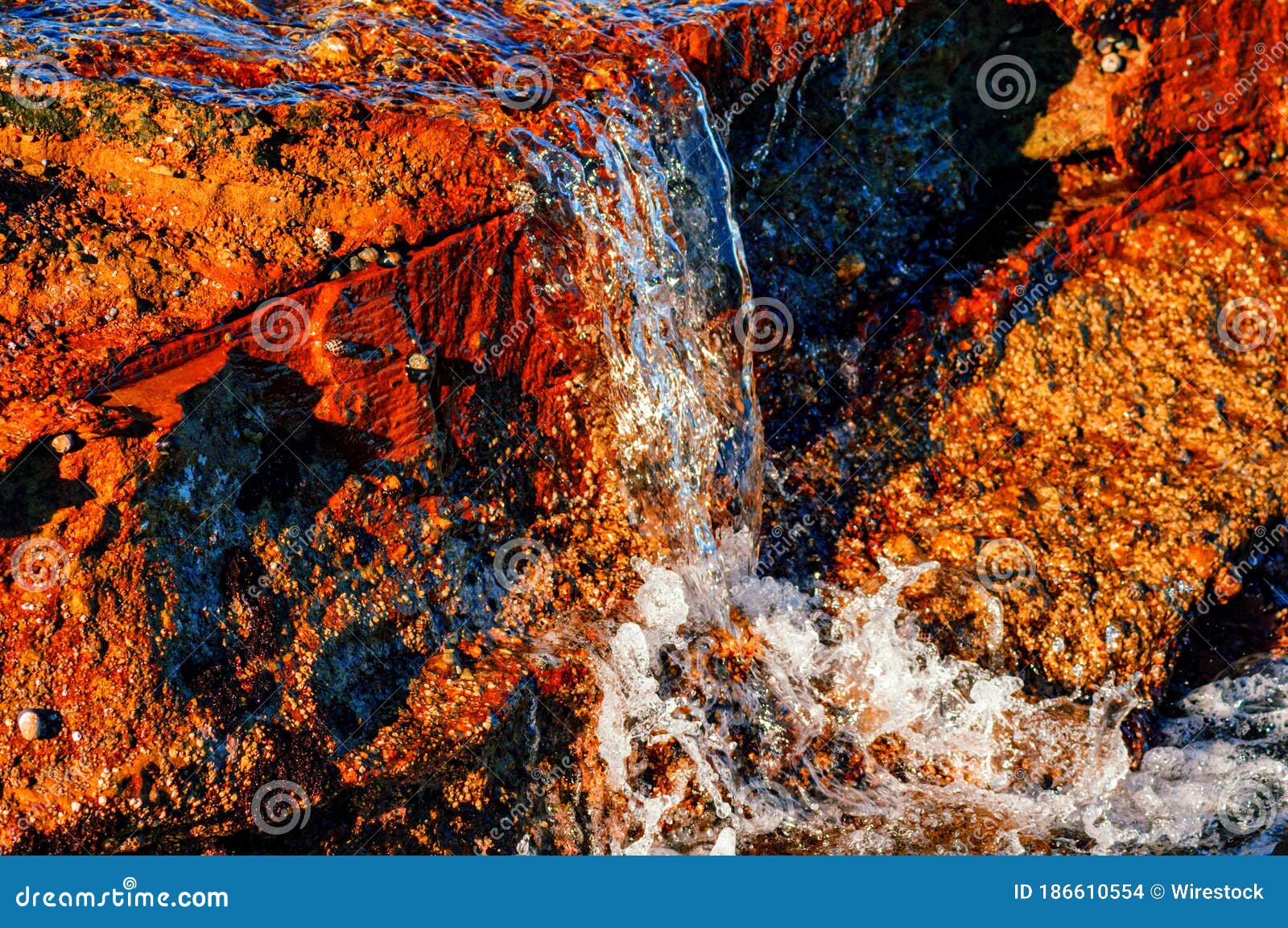 Water Pouring through the Rock Formations in the Sea Stock Photo ...