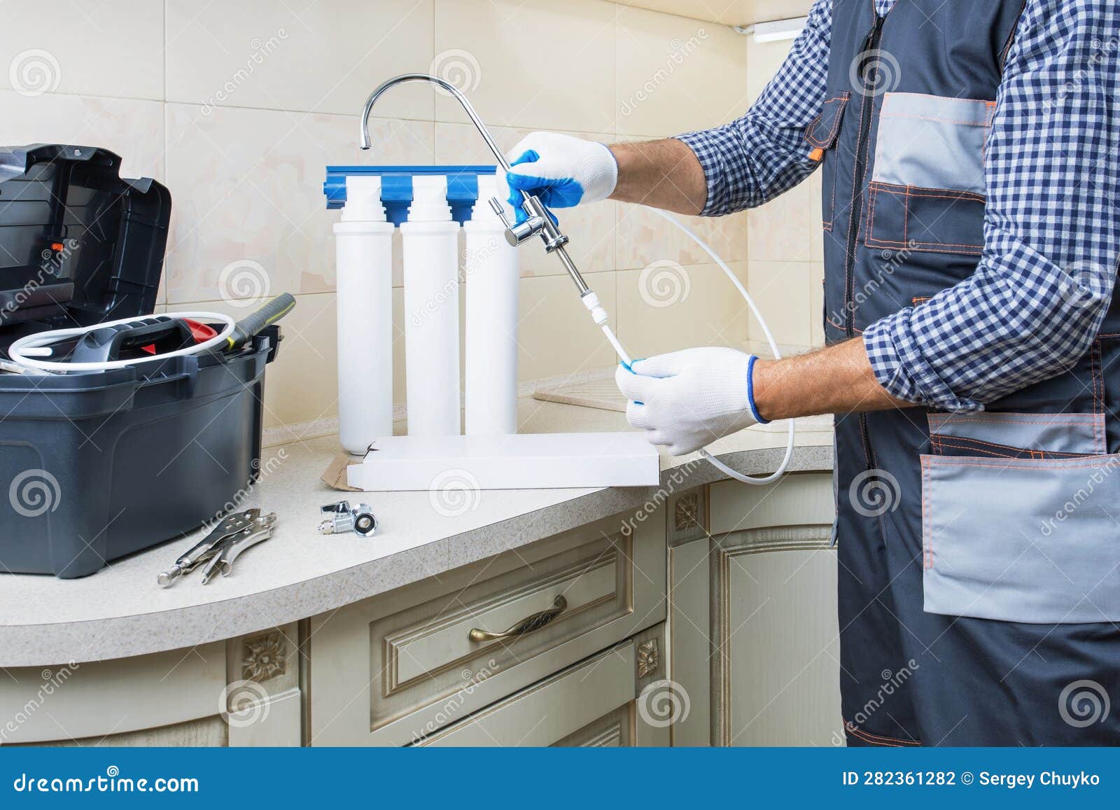 Plumber Hands in Gloves Replace Water Filter Cartridges at Home Kitchen ... Plumber Hands in Gloves Replace Water Filter Cartridges at Home Kitchen ...
