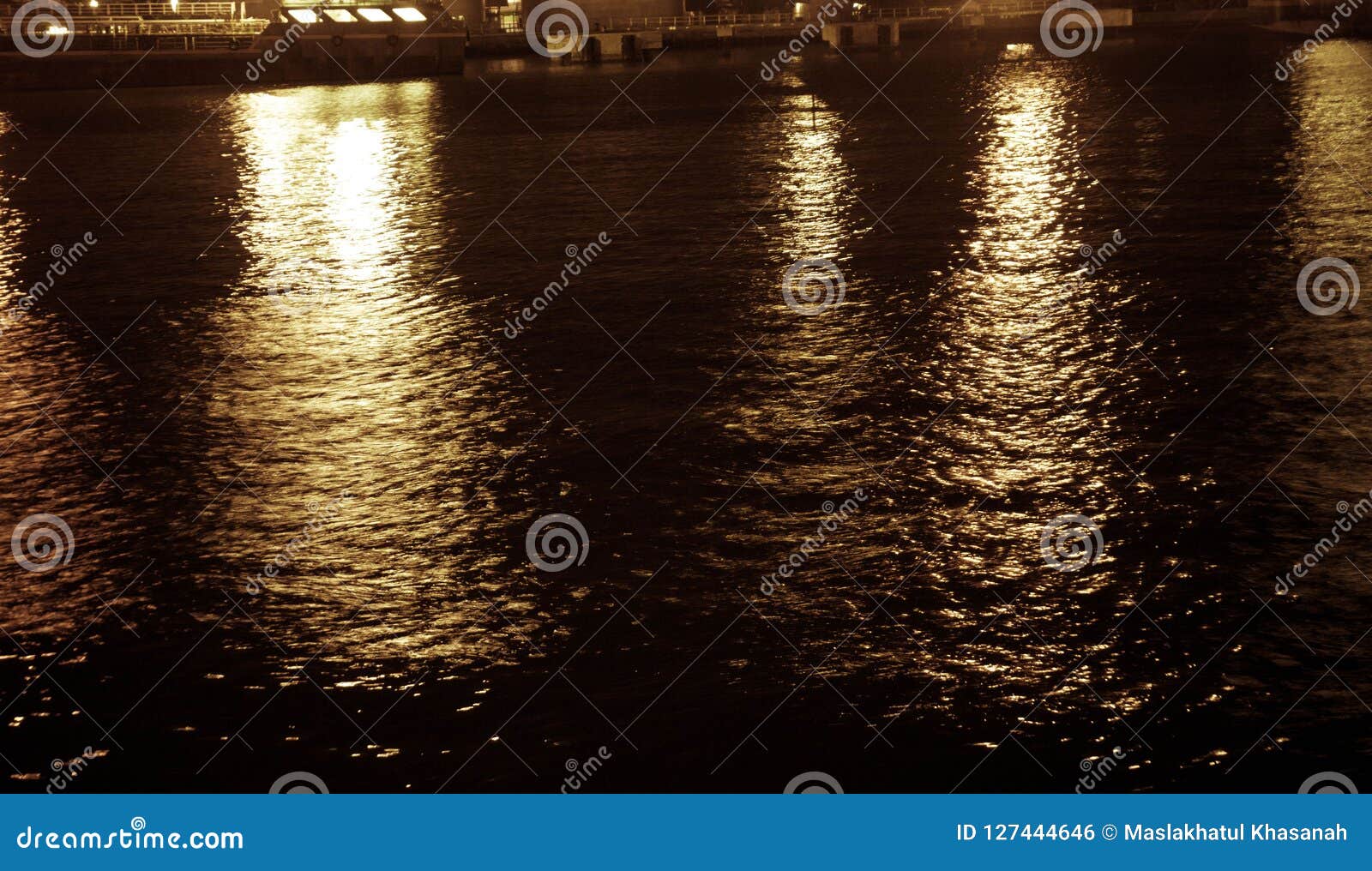 Water Ripple on the Night with Yellow Light Reflection from the Port ...