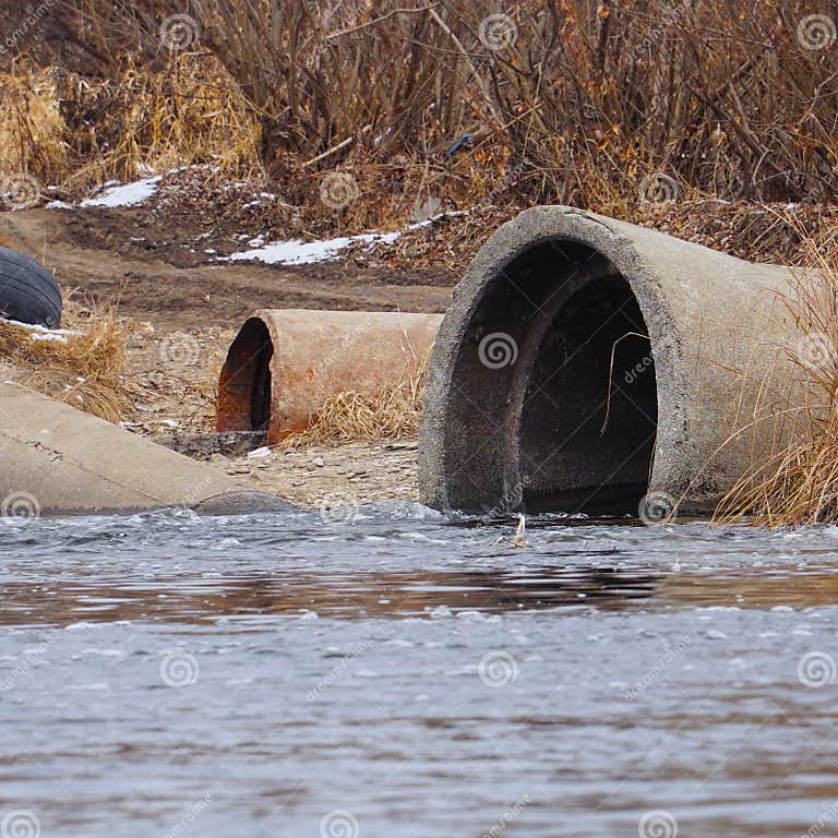 The Water on the River Flows from Large Pipes. Dam on River Stock Photo ...