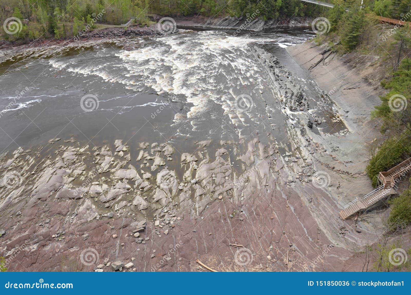 Water and Riverbed with Grey and Red Rocks Stock Photo - Image of ...