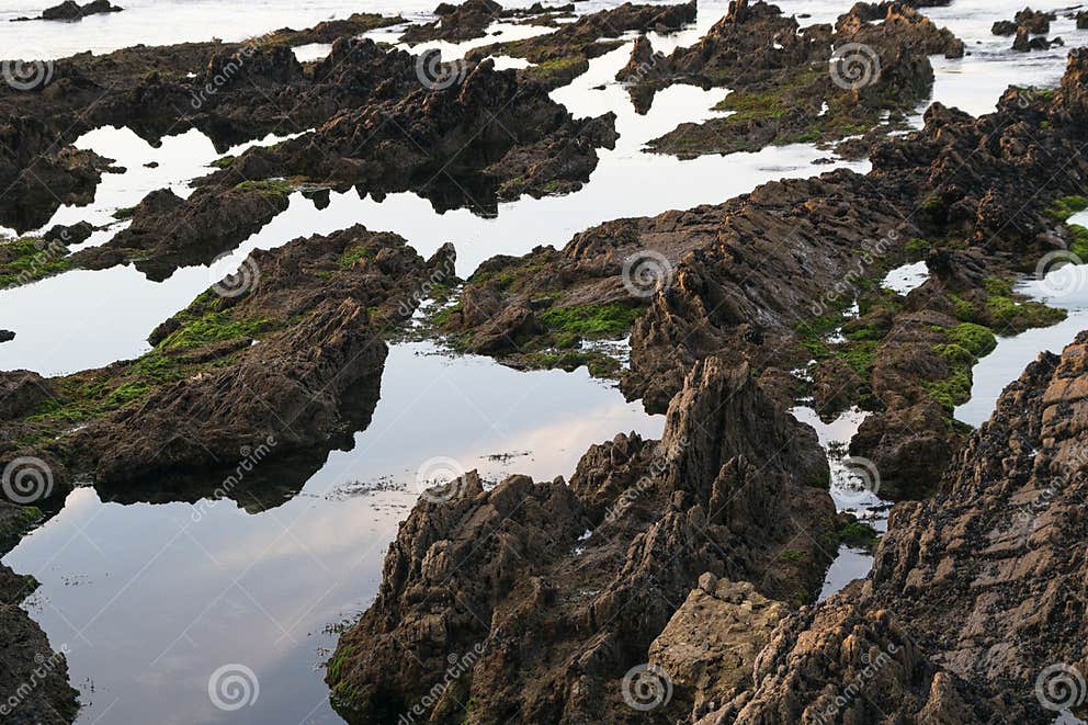 Water between a Rock Formation on the Seashore. Stock Photo - Image of ...