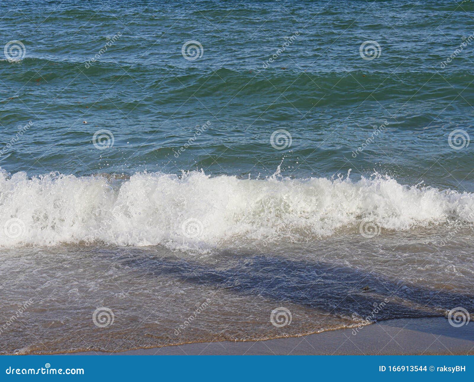 Waves Roll and Crash in Small Wavelets To the Beach Stock Photo - Image ...