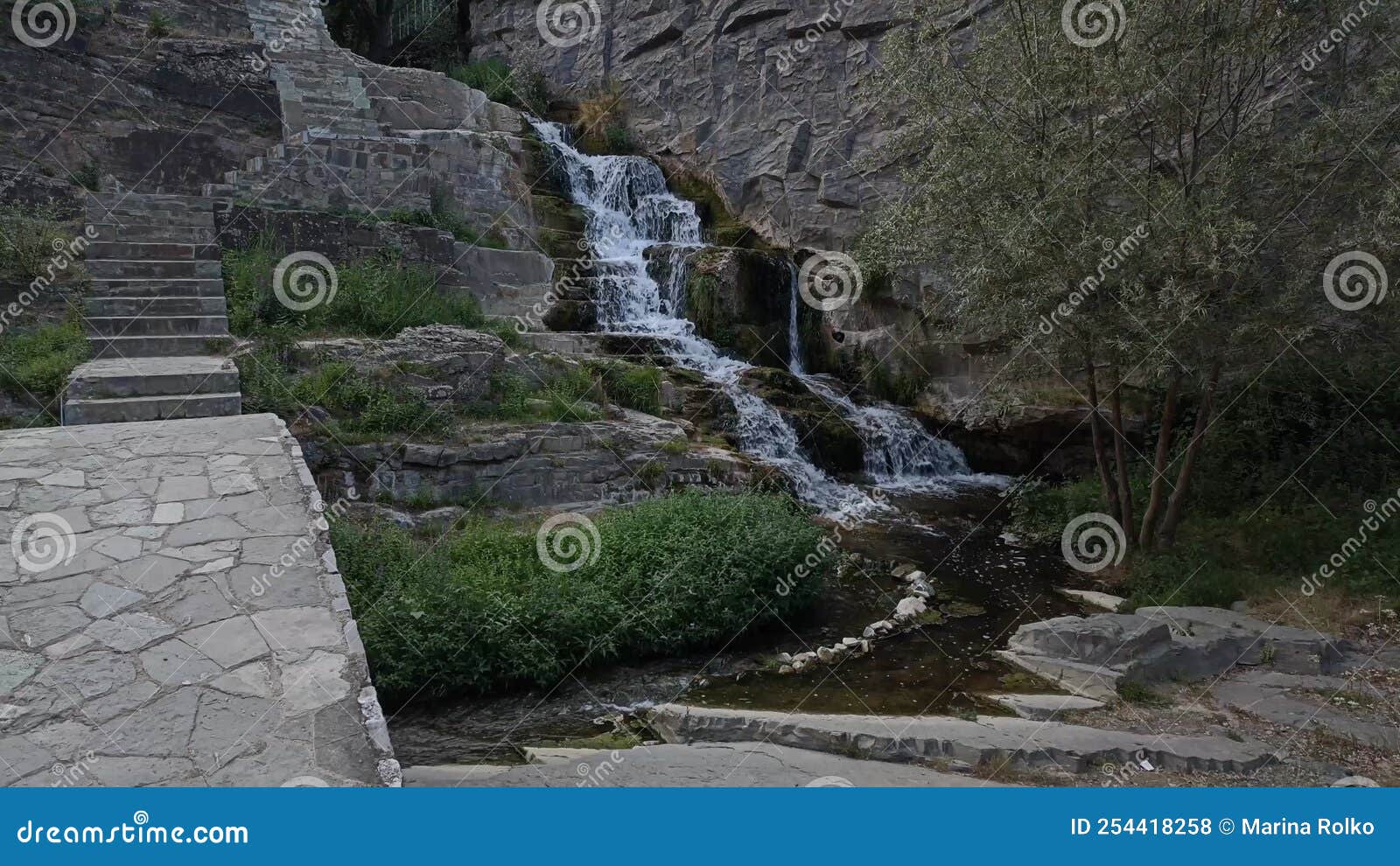 Water Running Down the Steps and a Stone Bridge To the Left Stock ...