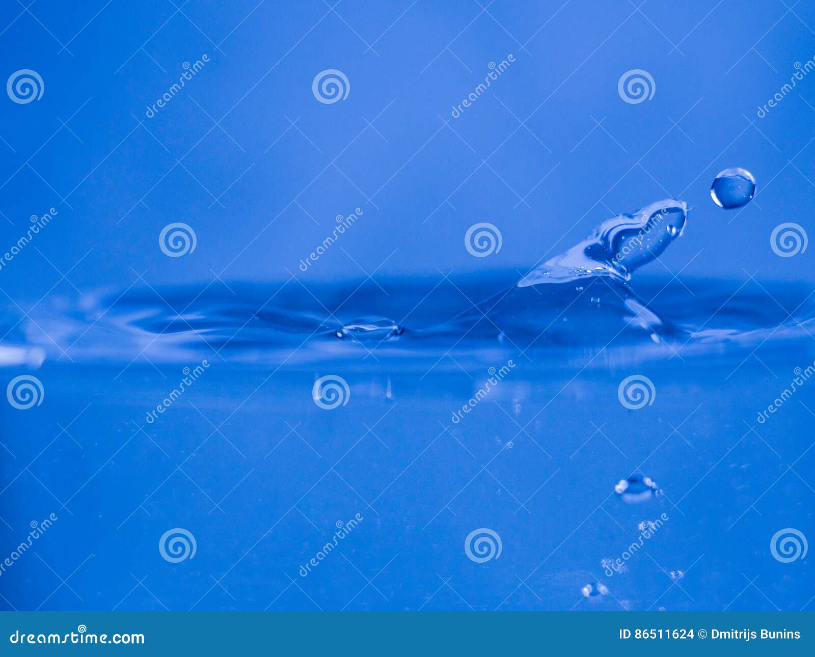 Water Splash in Blue Color with a Drop Coming Out from Water Stock ...