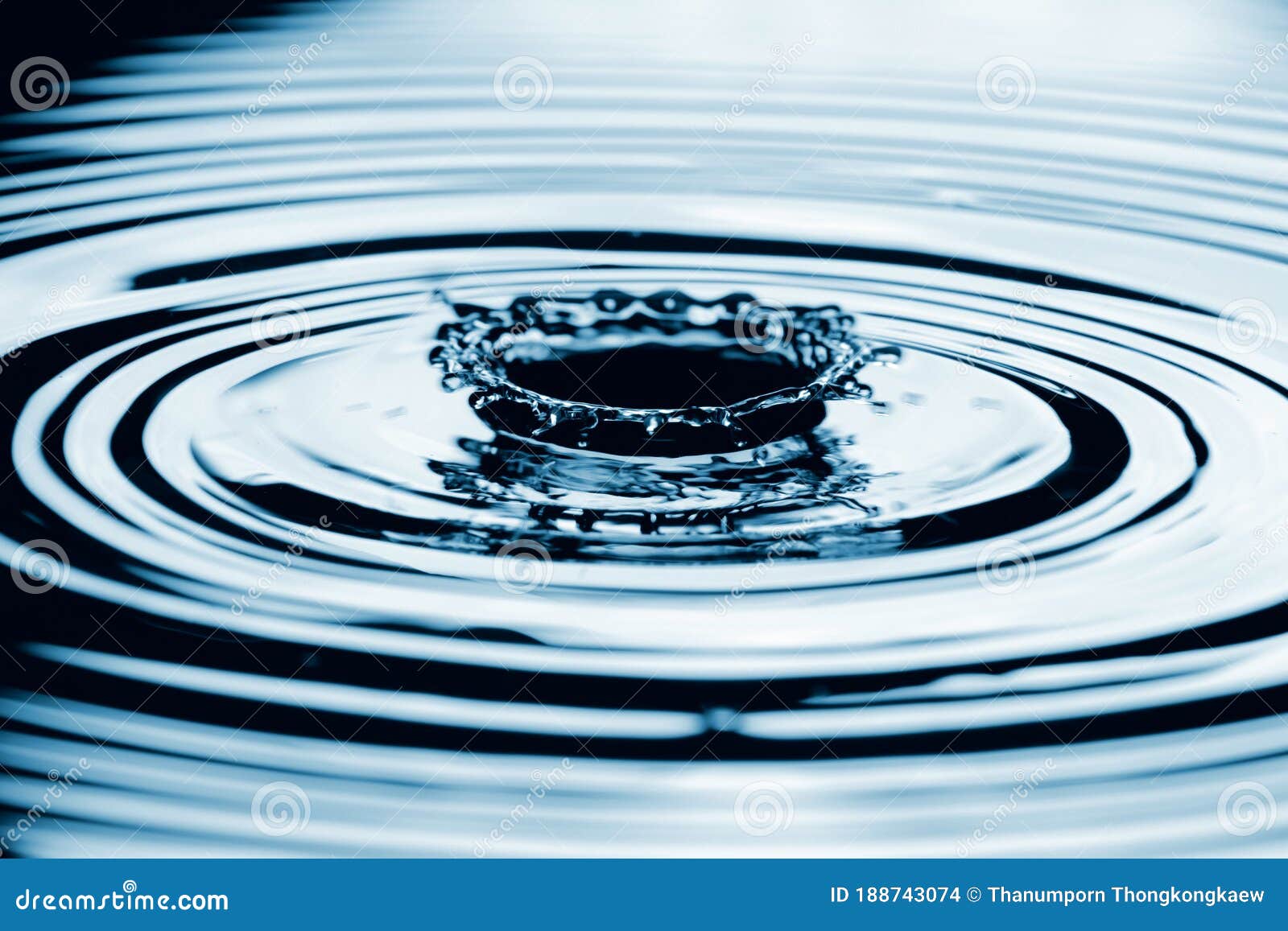 Water Splash in Dark Blue Color with a Drop of Water Flying from Above ...