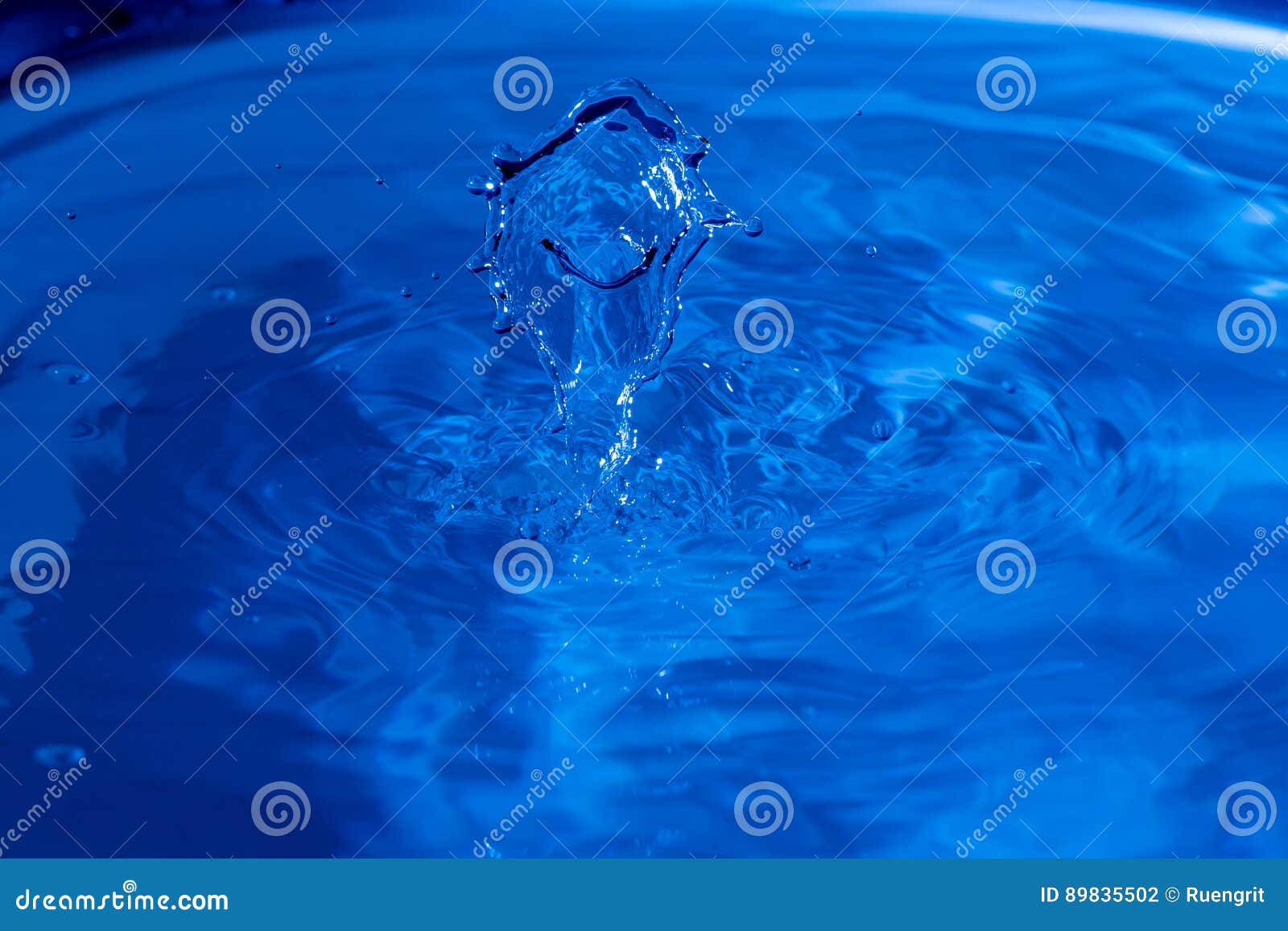 Water Splash in Dark Blue Color with a Drop of Water Flying from Stock ...