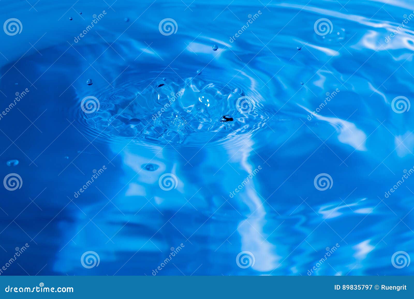 Water Splash in Dark Blue Color with a Drop of Water Flying from Stock ...