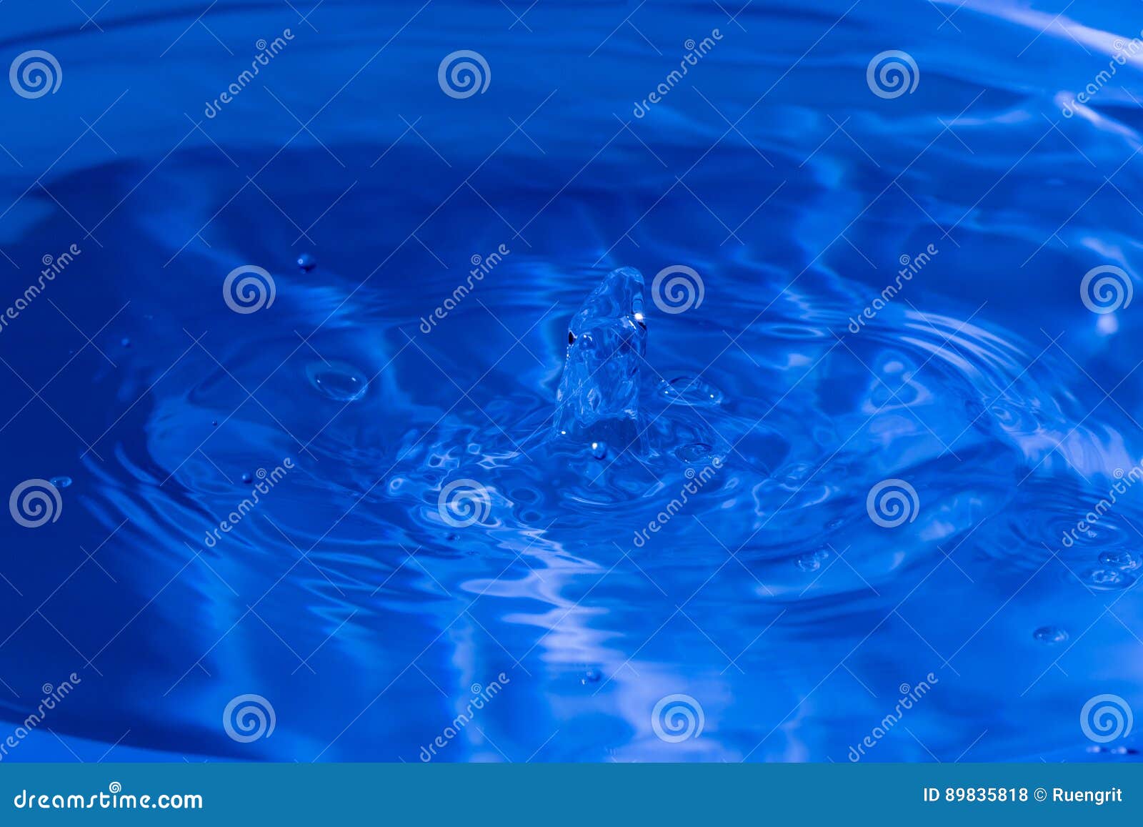Water Splash in Dark Blue Color with a Drop of Water Flying from Stock ...