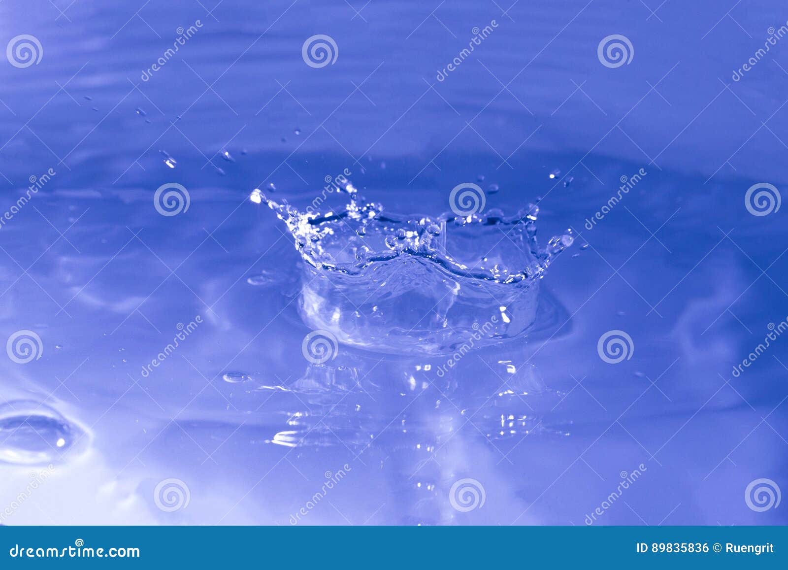 Water Splash in Dark Blue Color with a Drop of Water Flying from Stock ...