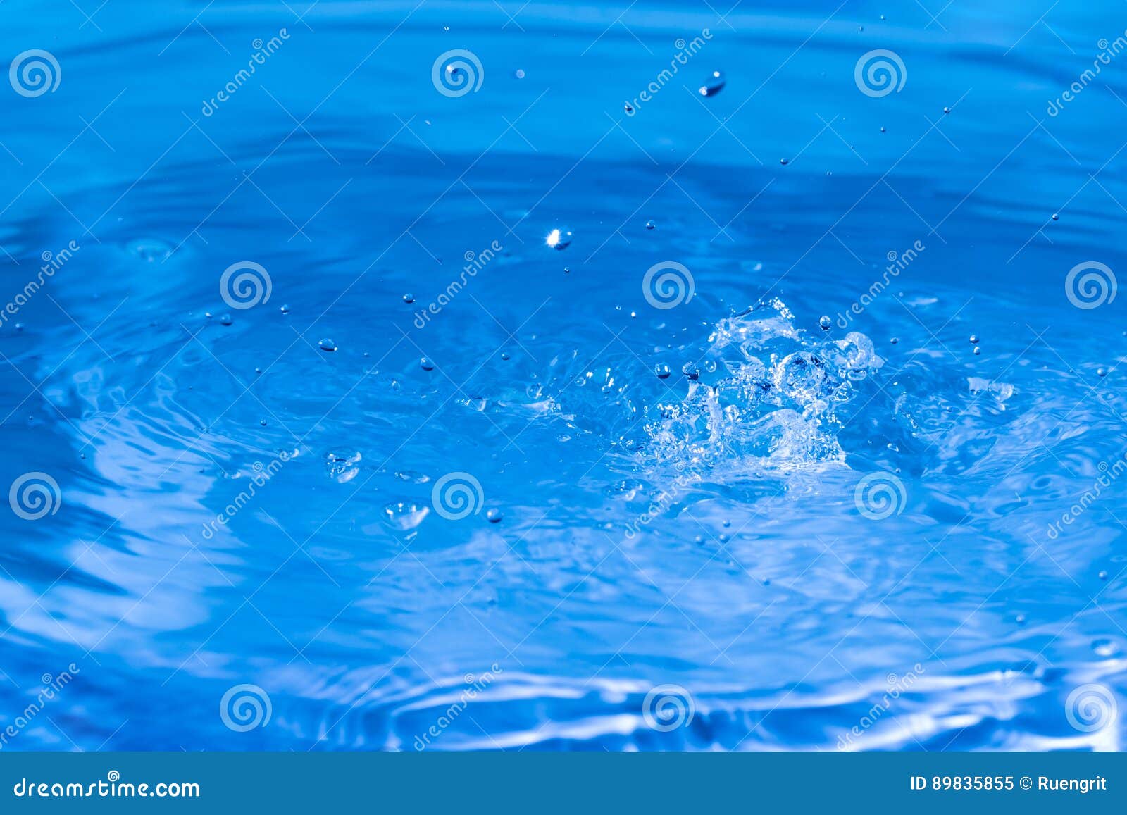 Water Splash in Dark Blue Color with a Drop of Water Flying from Stock ...