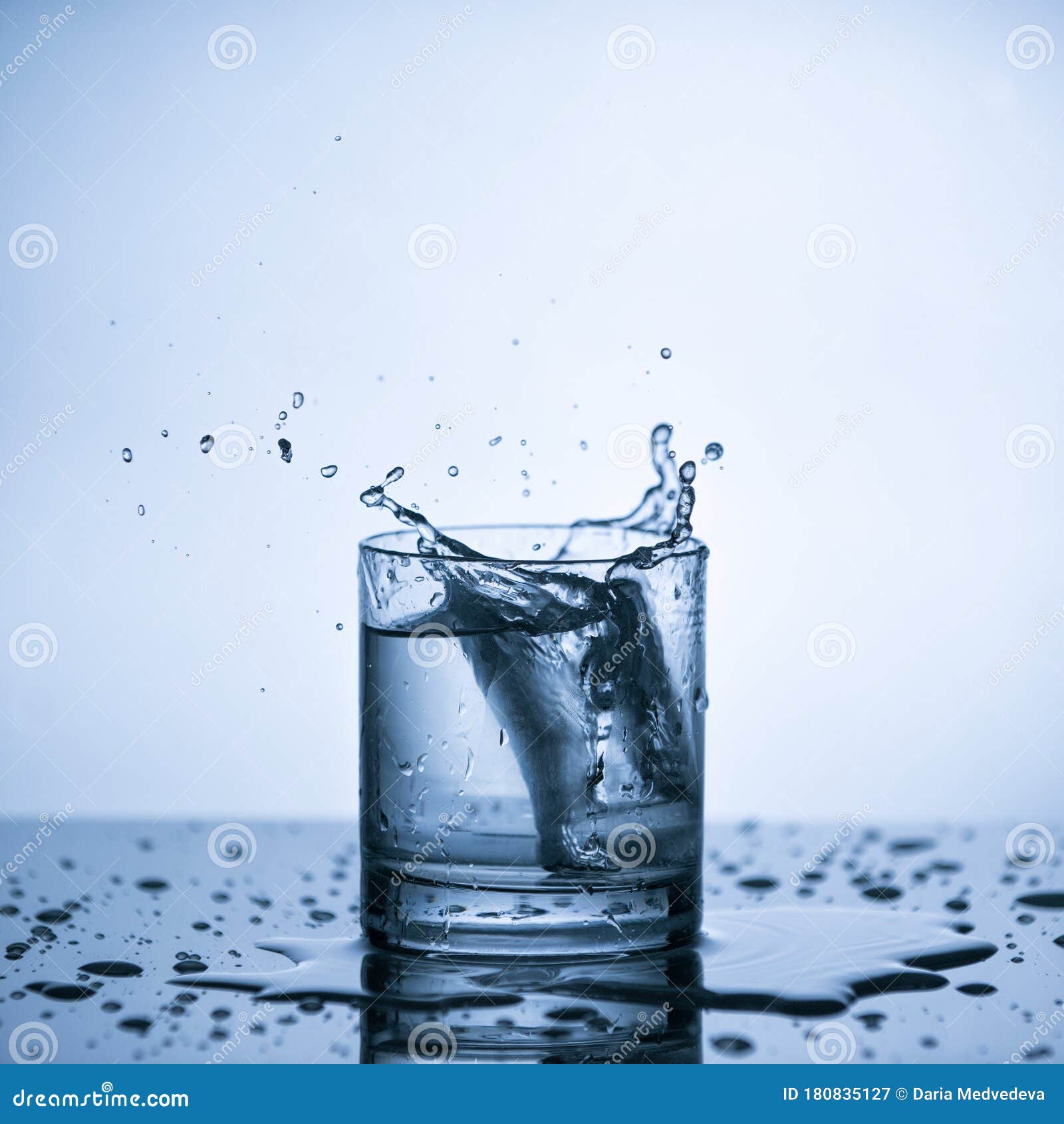 Water Splash from Ice Cube in the Glass of Water Stock Image - Image of ...