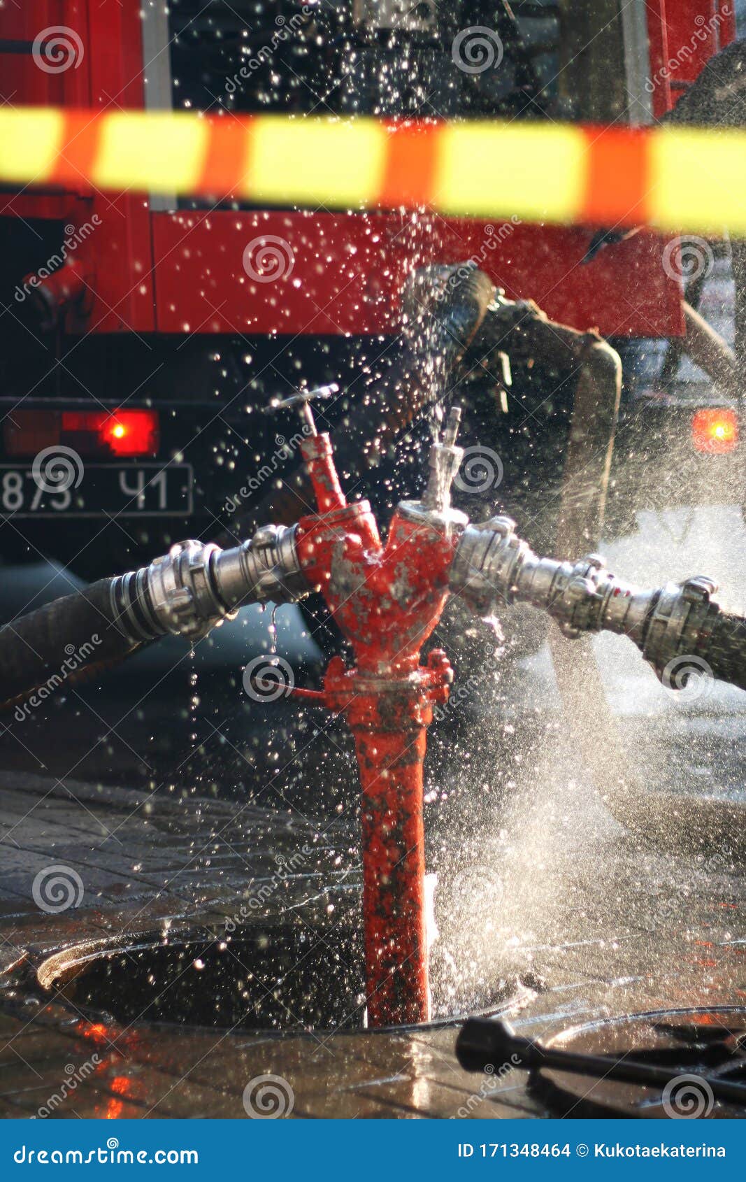 Water Splashes from the Fire Hose and Hydrant Connections. Firefighters ...