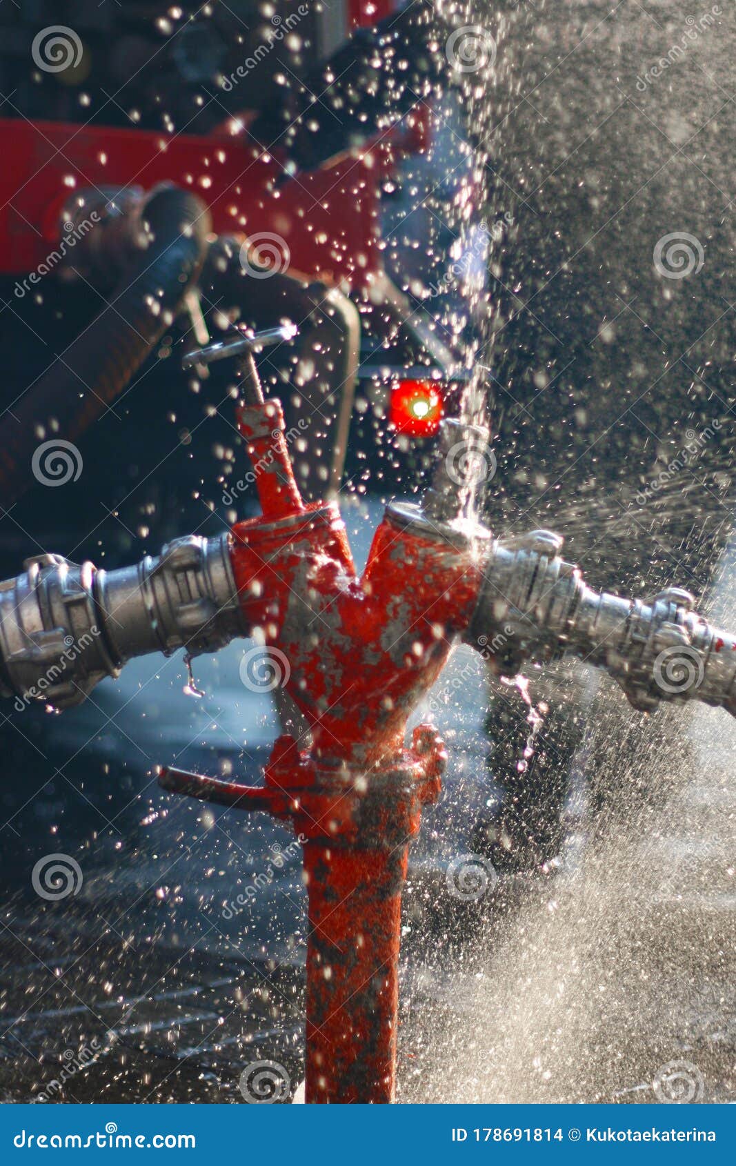 Water Splashes from the Fire Hose and Hydrant Connections. Firefighters ...