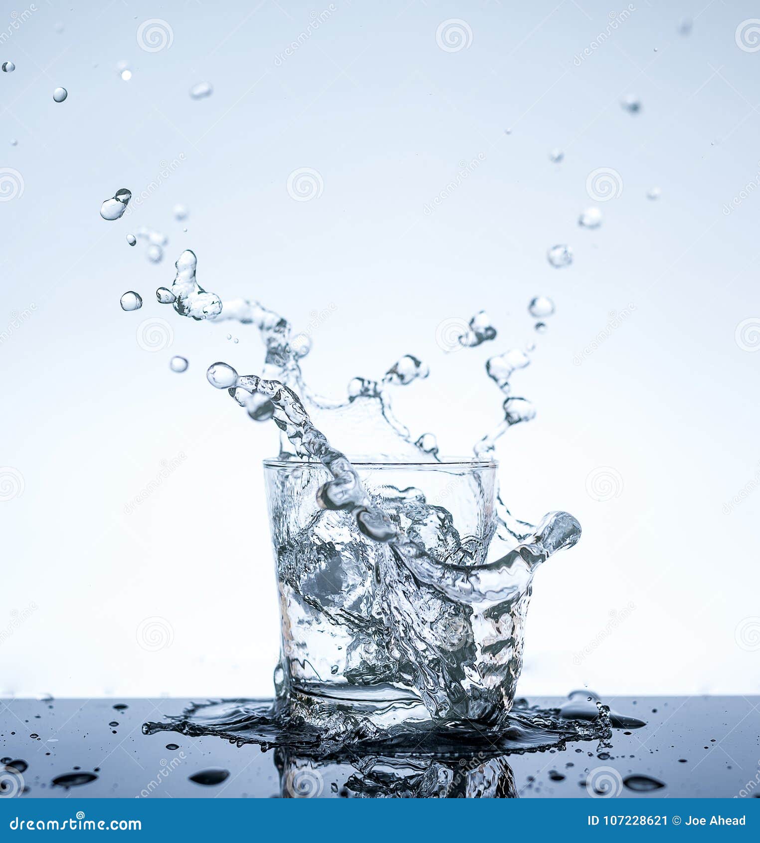 Water Splashing in the Glass with Reflection on Mirror. Stock Image ...