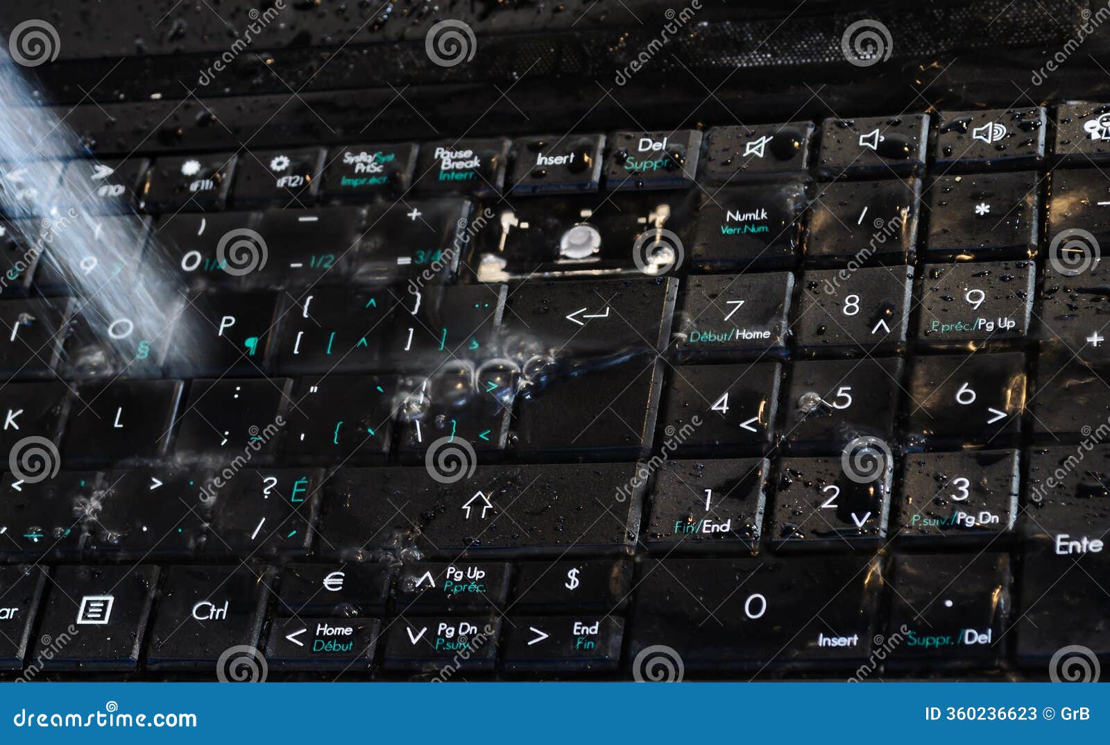 Water Spray Pouring Onto Laptop Computer Keyboard with Bilingual Keys ...