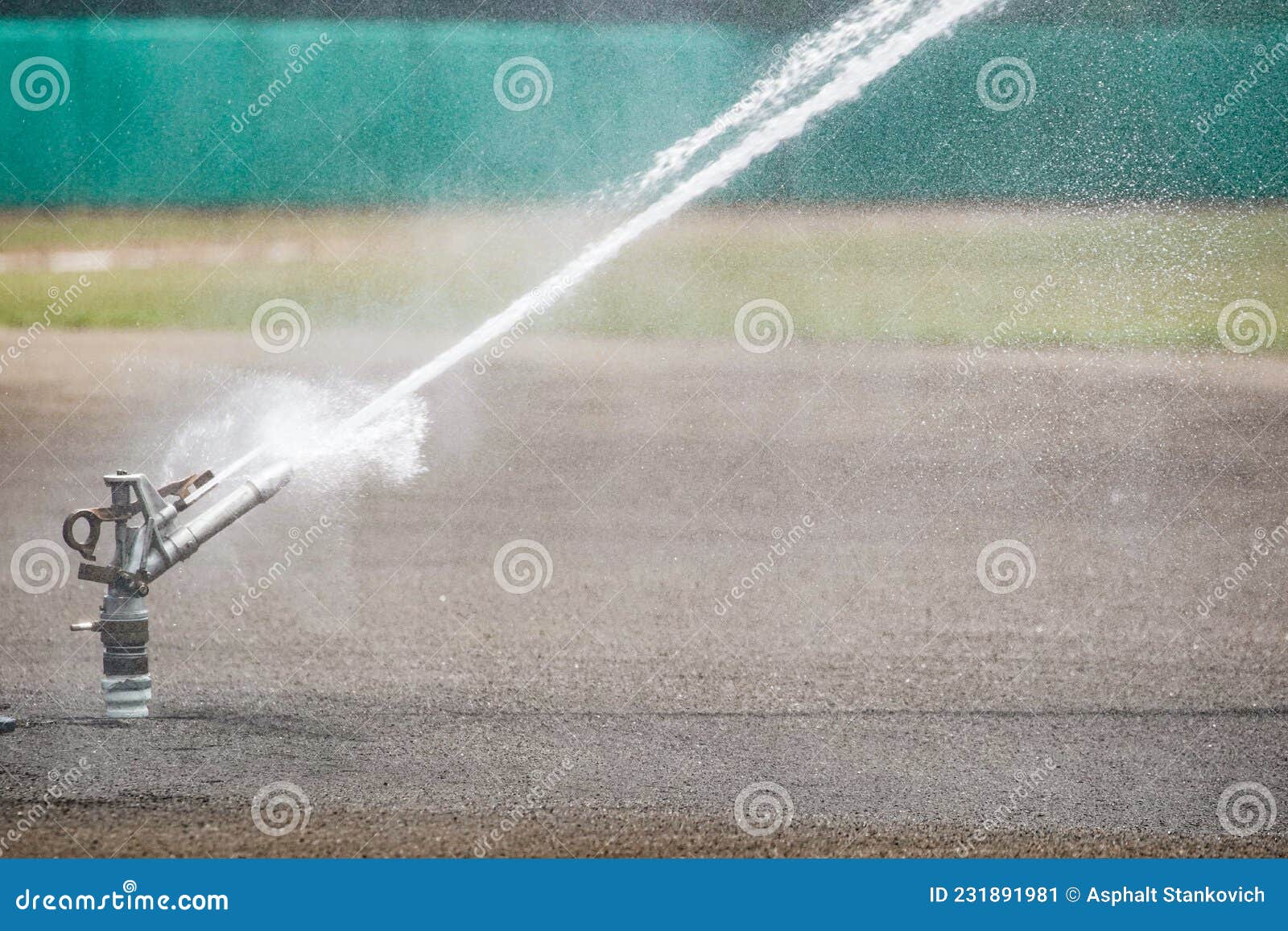 Water Sprayed from a Sprinkler at a Baseball Field. Stock Image - Image ...