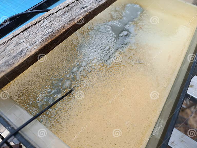 Water Surface with Bubbles and Rust Due To an Electrolysis Process ...