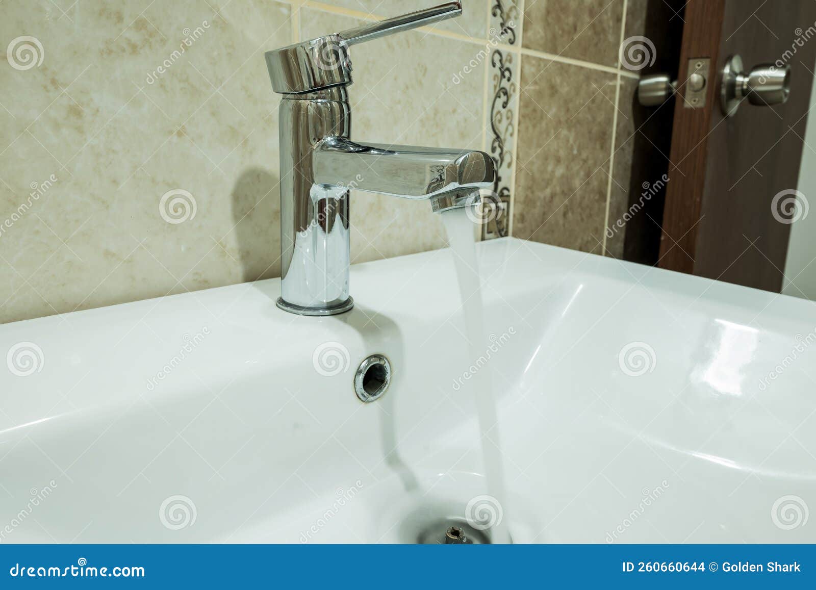 A Water Tap with Clear Water Running Down into the Sink Stock Photo ...