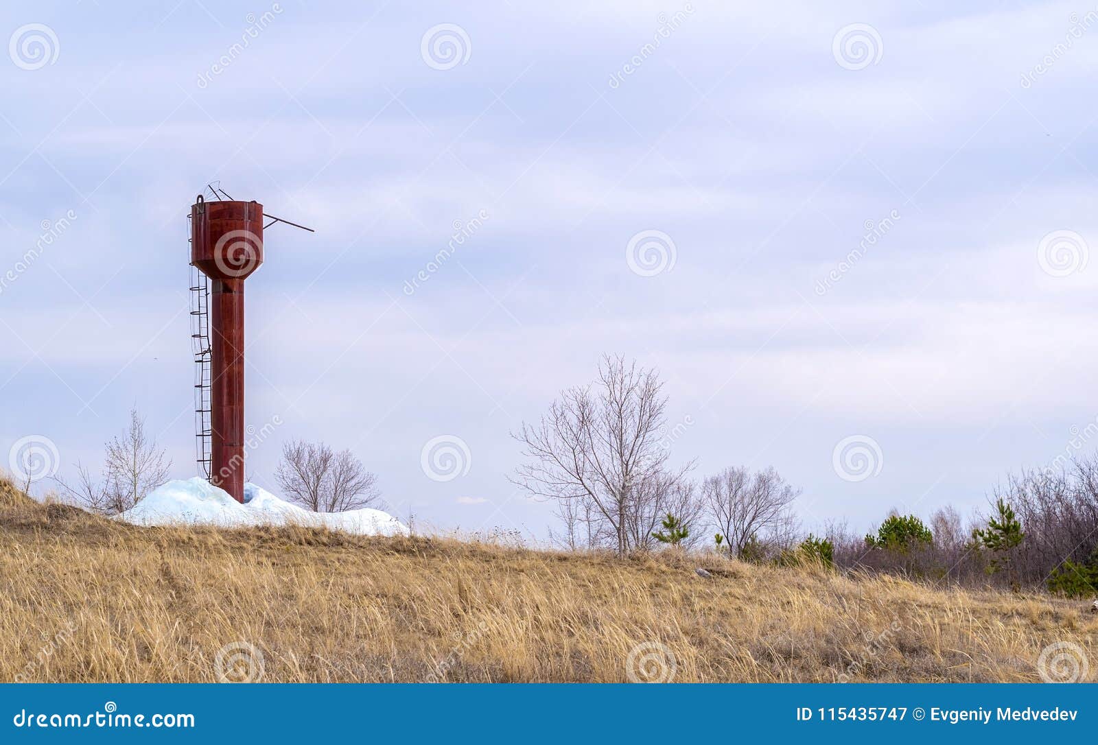 Water Tower on a Hill in the Snow Stock Image - Image of clouds, rural ...