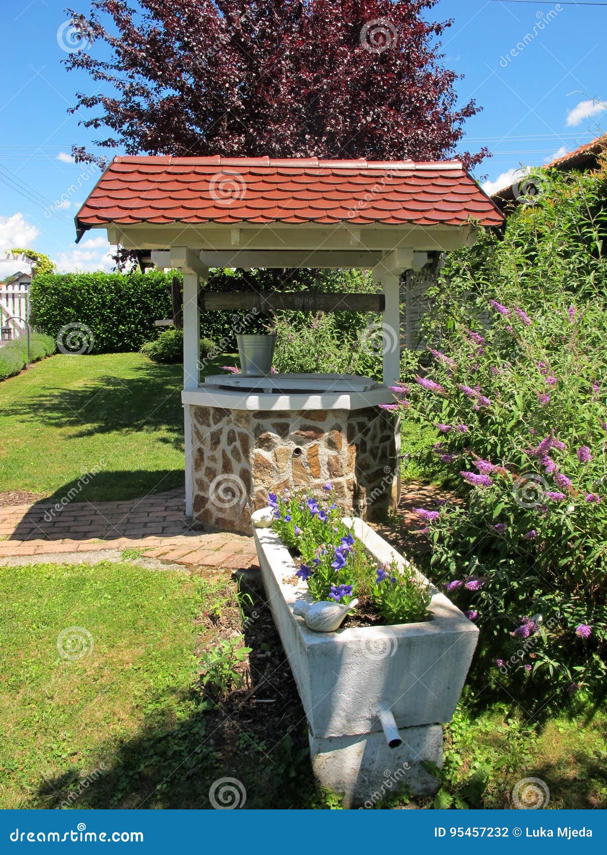 WATER WELL in a GARDEN stock photo. Image of country - 95457232
