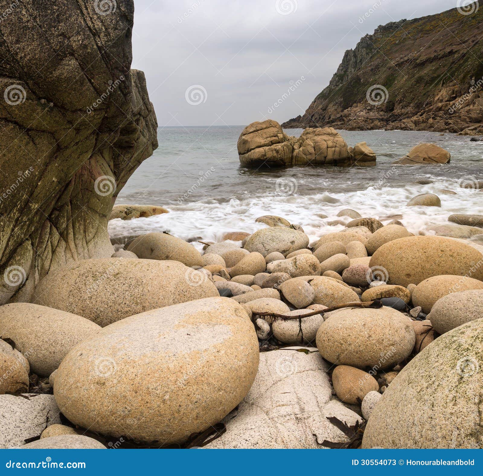 Water Worn Ancient Rocks on Beach Stock Image - Image of brisons, beach ...