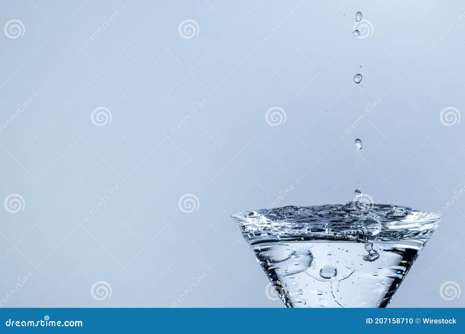 Waterdrops Dropping into a Glass Filled with Water Stock Photo - Image ...