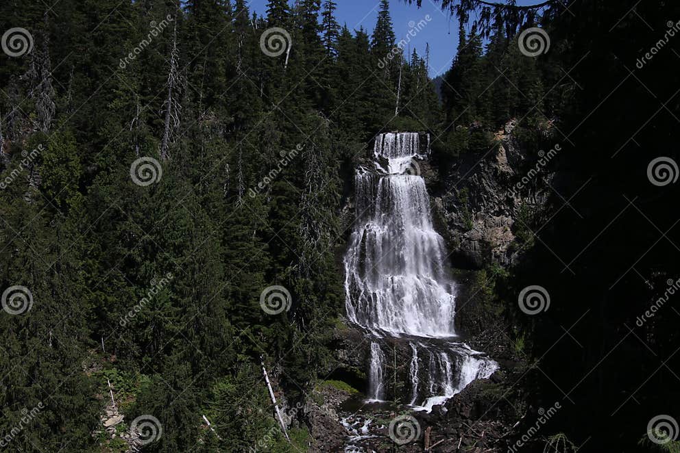 A Waterfall Cascading Down the Side of a Mountain Stock Photo - Image ...