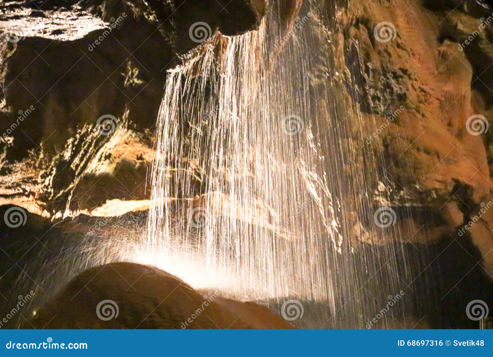 Waterfall in Cavern stock photo. Image of stalagmites - 68697316
