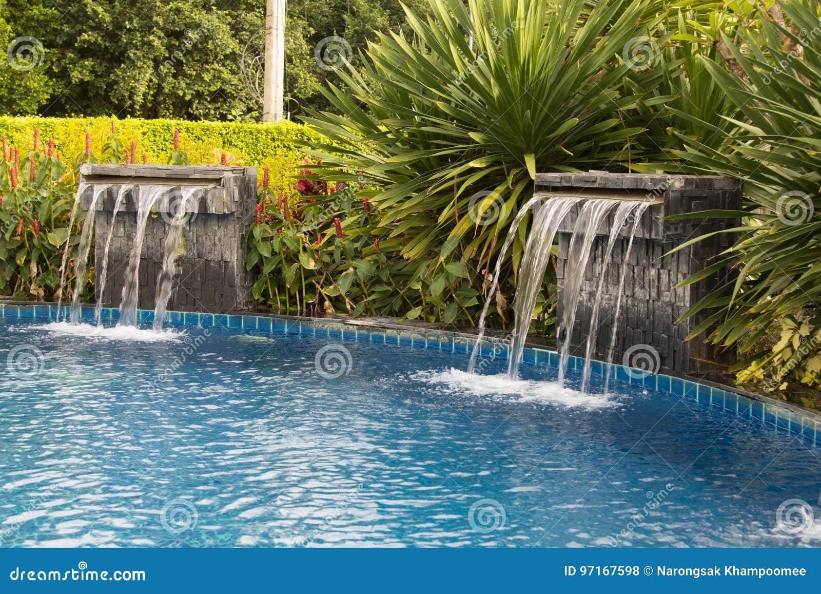 Waterfall Falling in a Blue Lagoon Swimming Pool in Hotel. Stock Photo ...