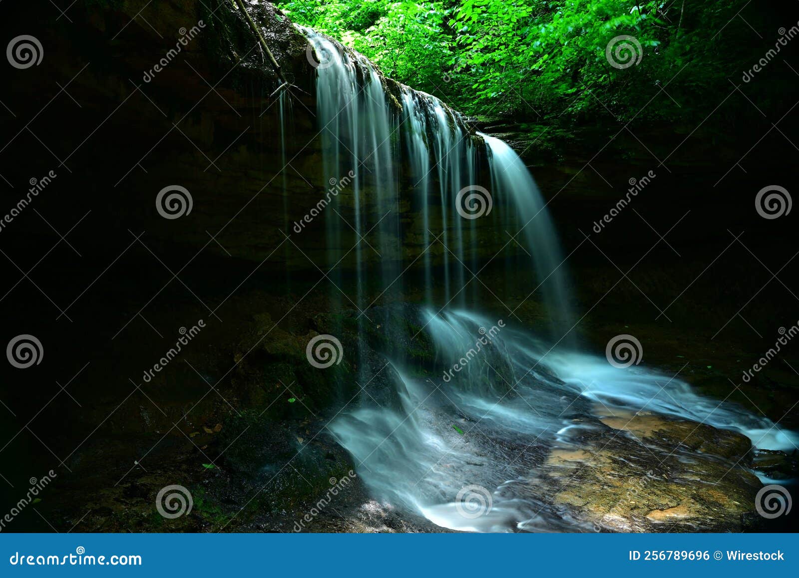 Waterfall Falling from Rocks Surrounded by Green Trees Stock Photo ...