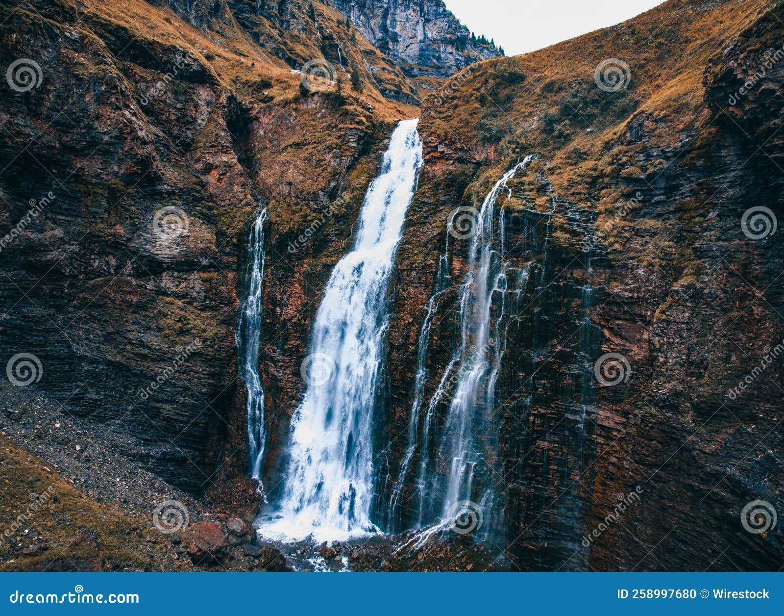 Waterfall Flowing Down the Rocks from a Mountain Stock Photo - Image of ...