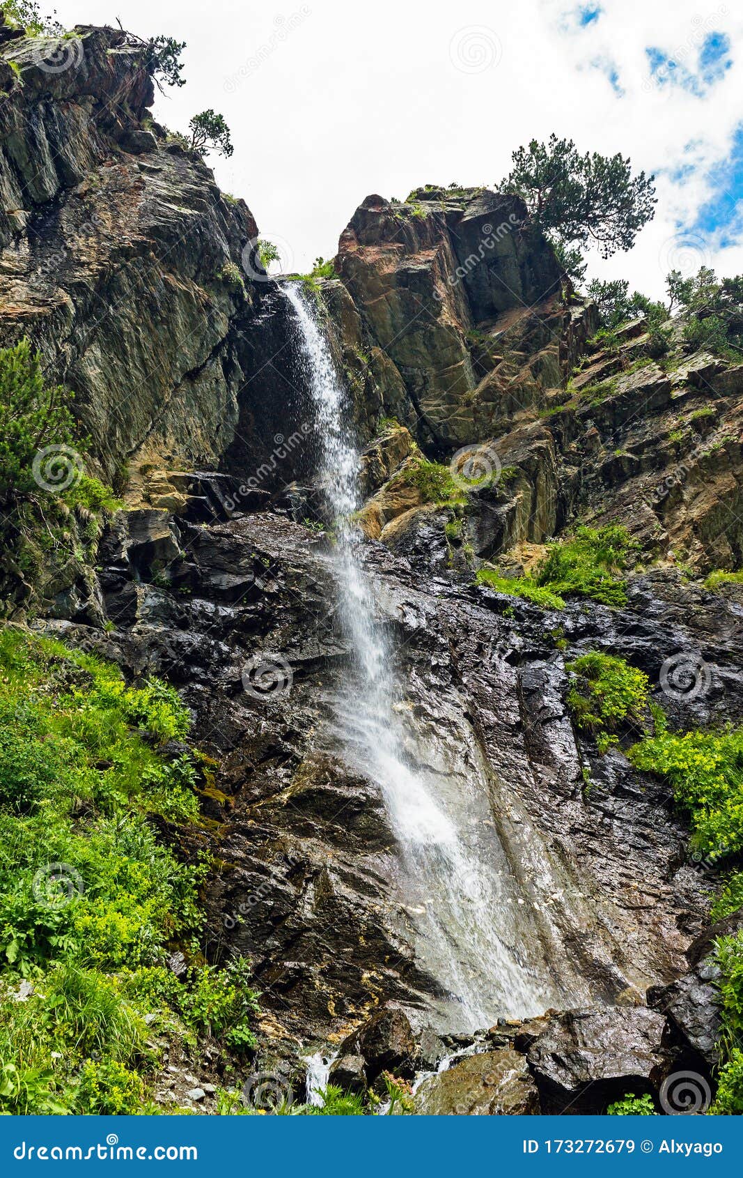 Waterfall Flowing Down a Steep Cliff in the Mountains Stock Image ...