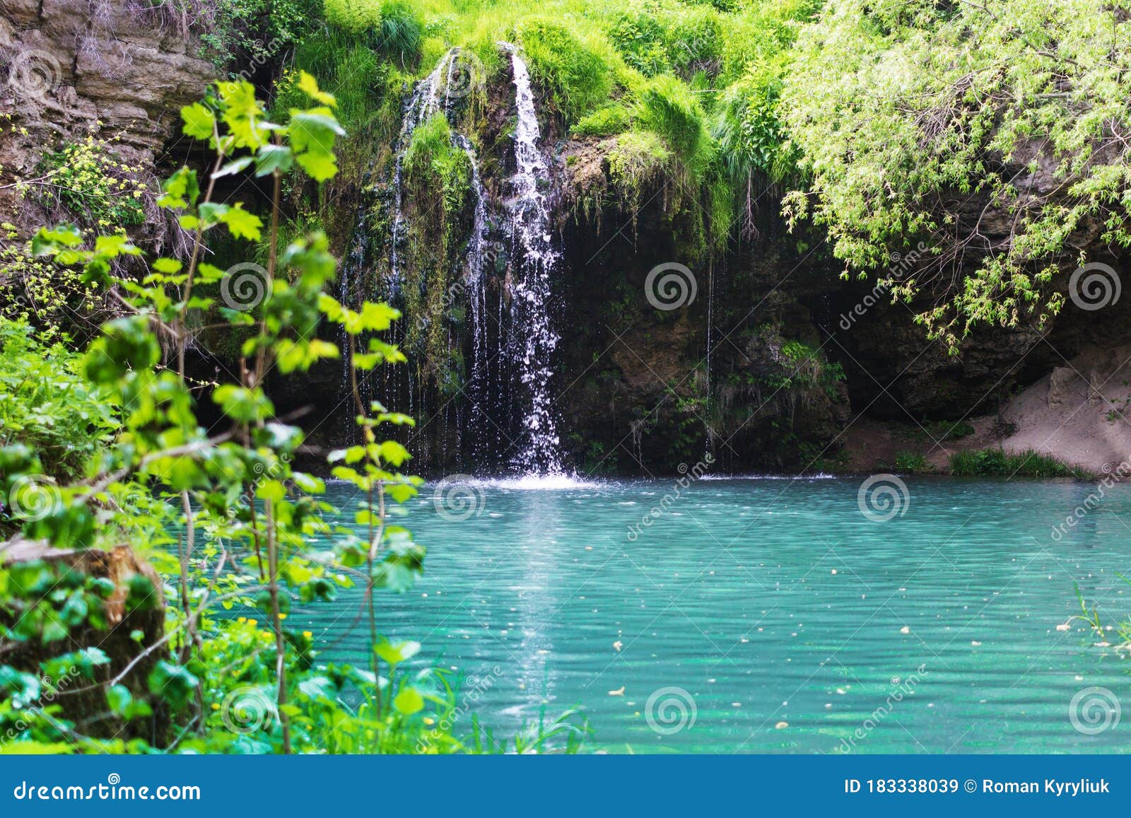 Waterfall that Flows into a Blue Lake with Clear Water Stock Image ...