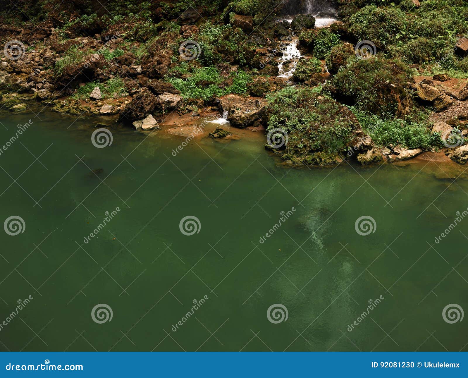 The Waterfall Flows into the Green Lake Stock Photo - Image of ...