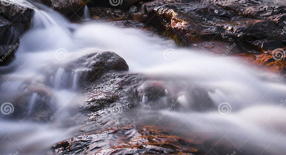 Waterfall over red rock stock photo. Image of three, silk - 30468418