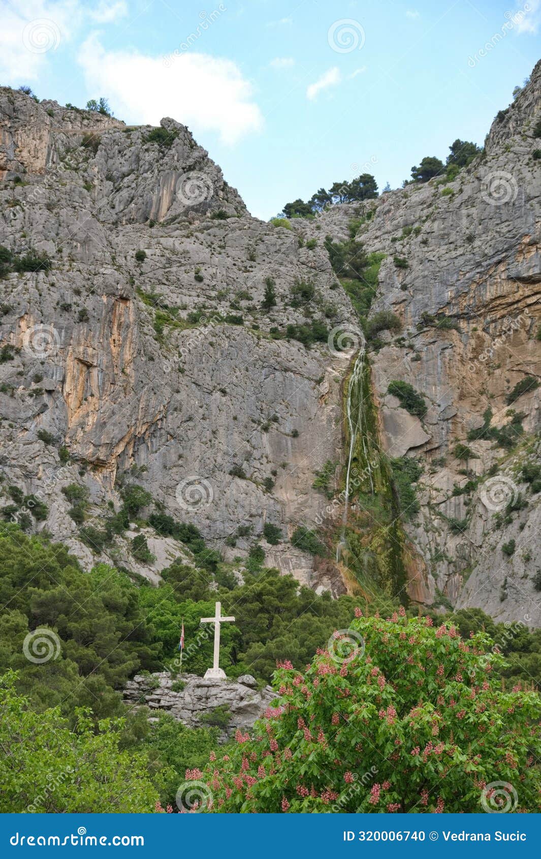 Waterfall Over a Rocky Cliff Stock Photo - Image of structure, clouds ...