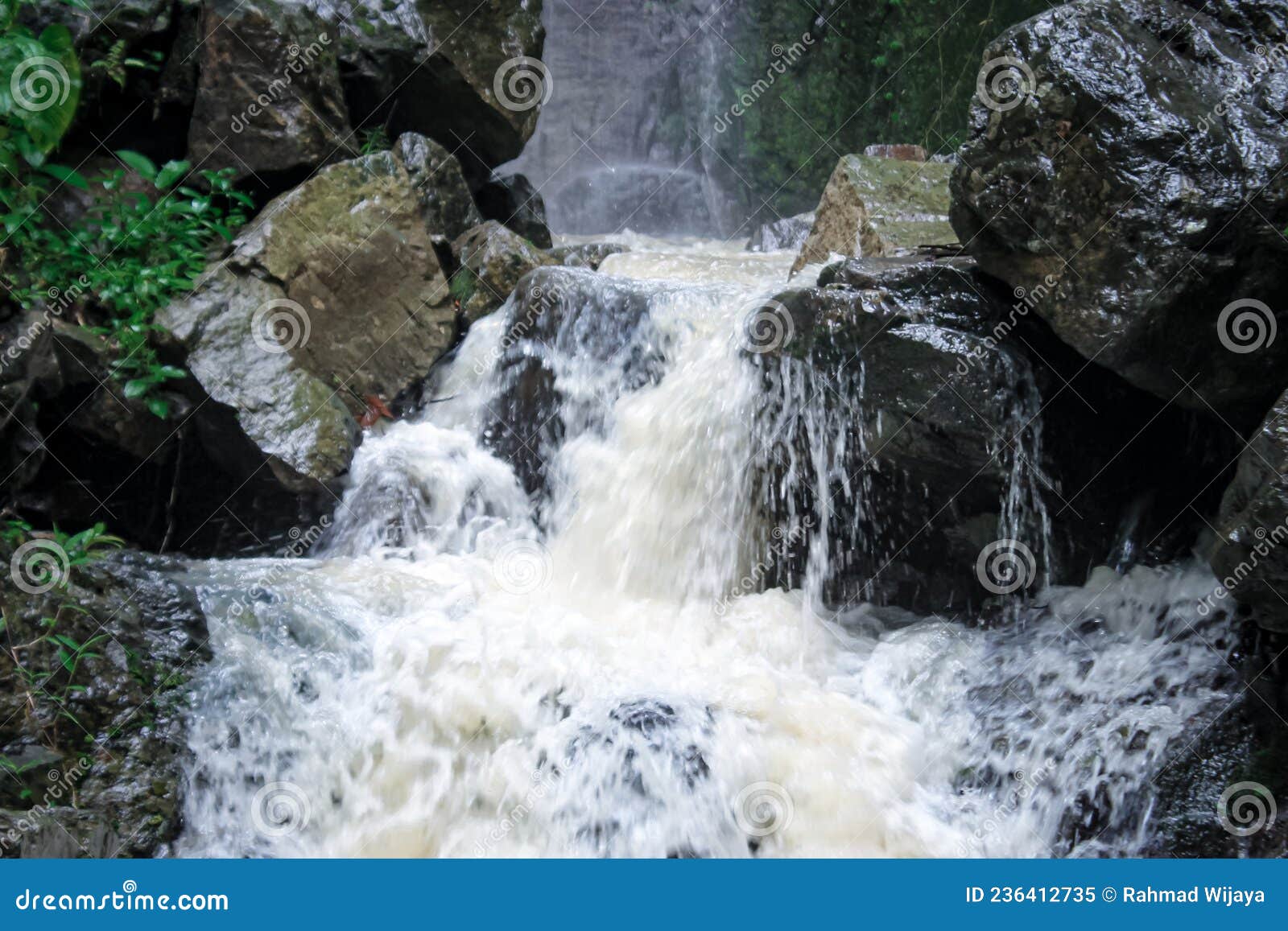 A Waterfall that Passes through the Rocks in the Interior of the Forest ...