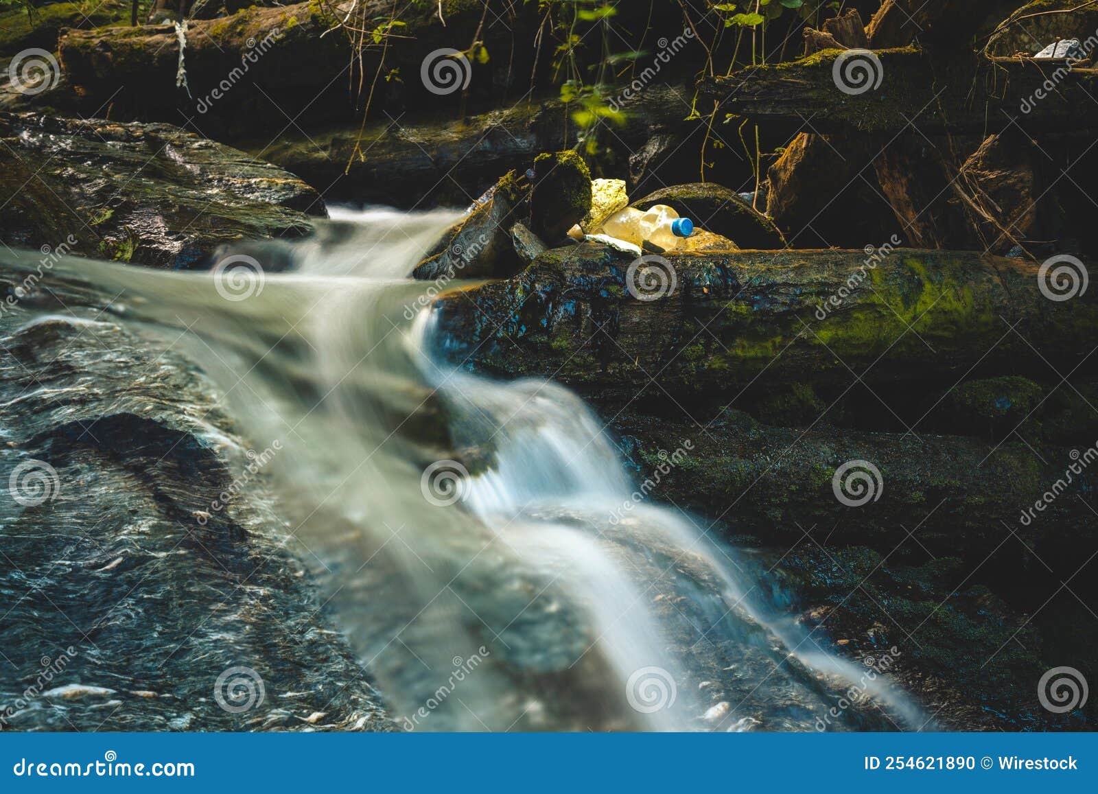Waterfall with Plastic Waste Washed Up on a Rock. Stock Photo - Image ...