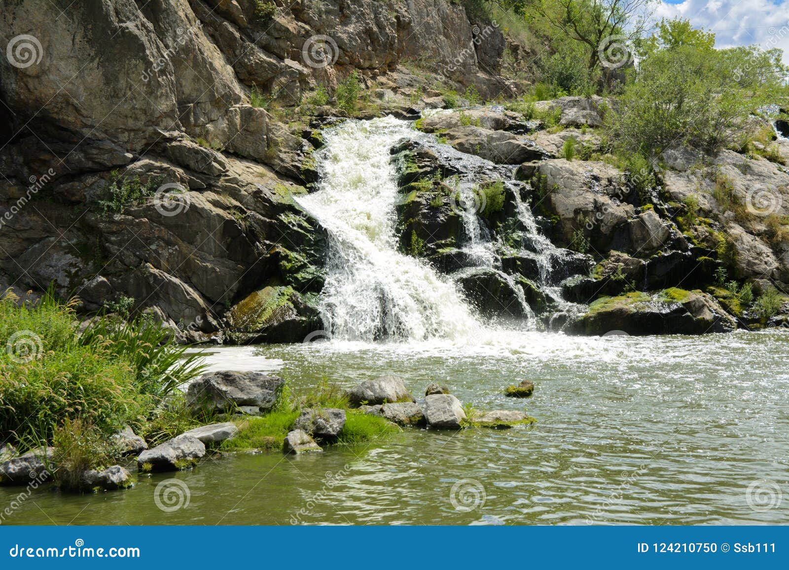 The Waterfall on the River Flows through and Over the Rocks Cove Stock ...
