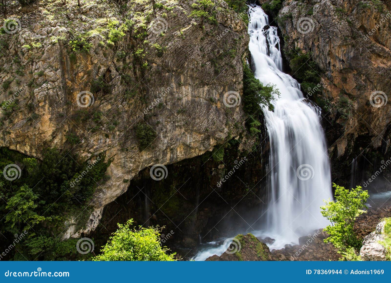 Waterfall in rocky cliff stock photo. Image of rocks - 78369944