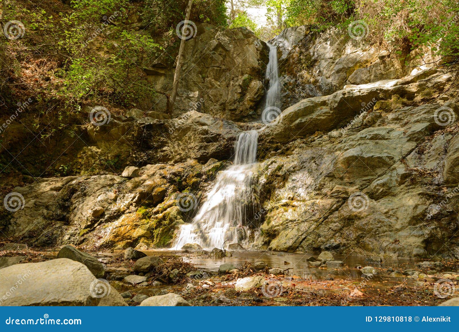Waterfall in rocky terrain stock photo. Image of dark - 129810818